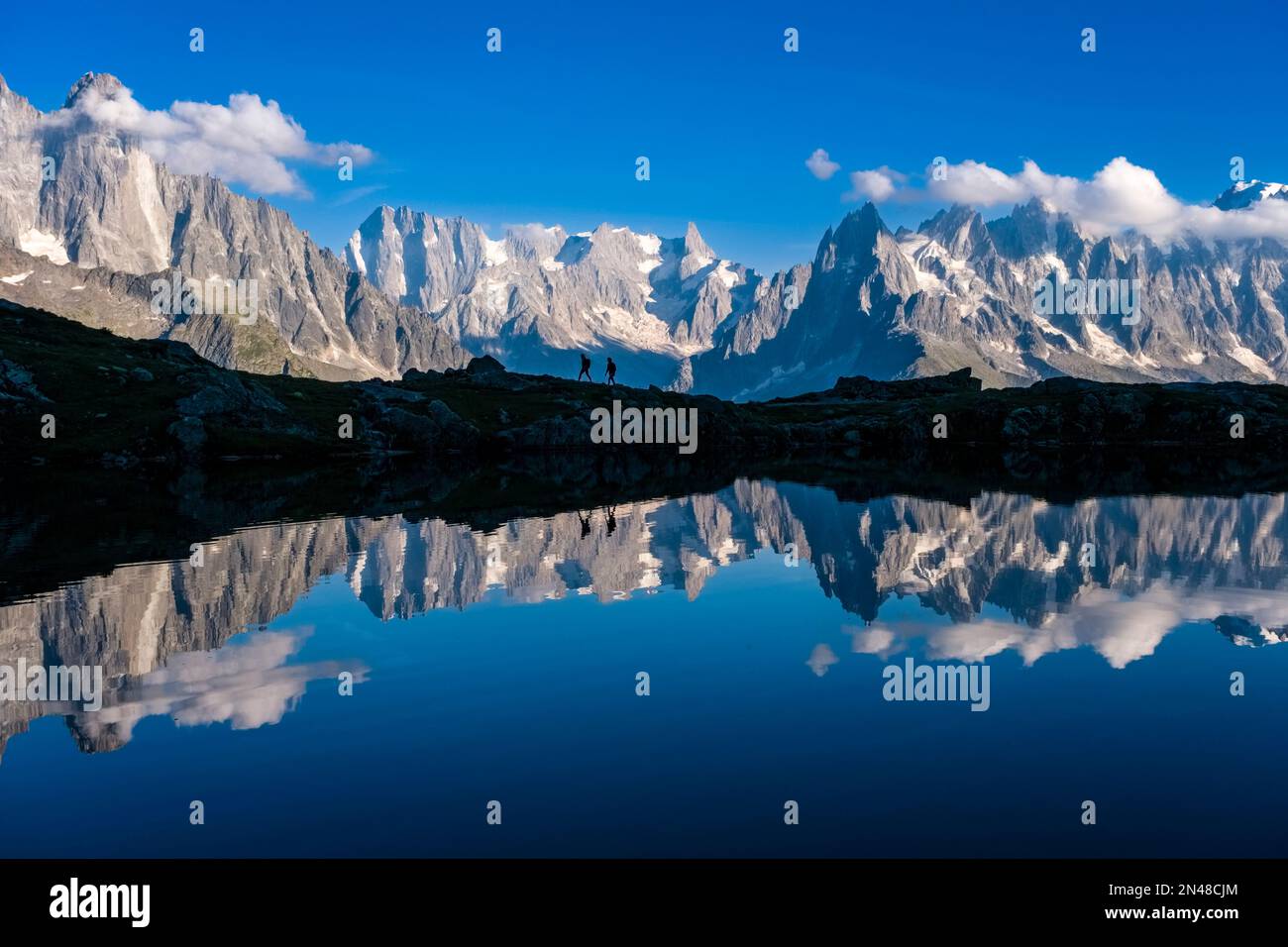 The peaks of the Mont Blanc massif are reflecting on the surface of Lacs des Chéserys, two ...