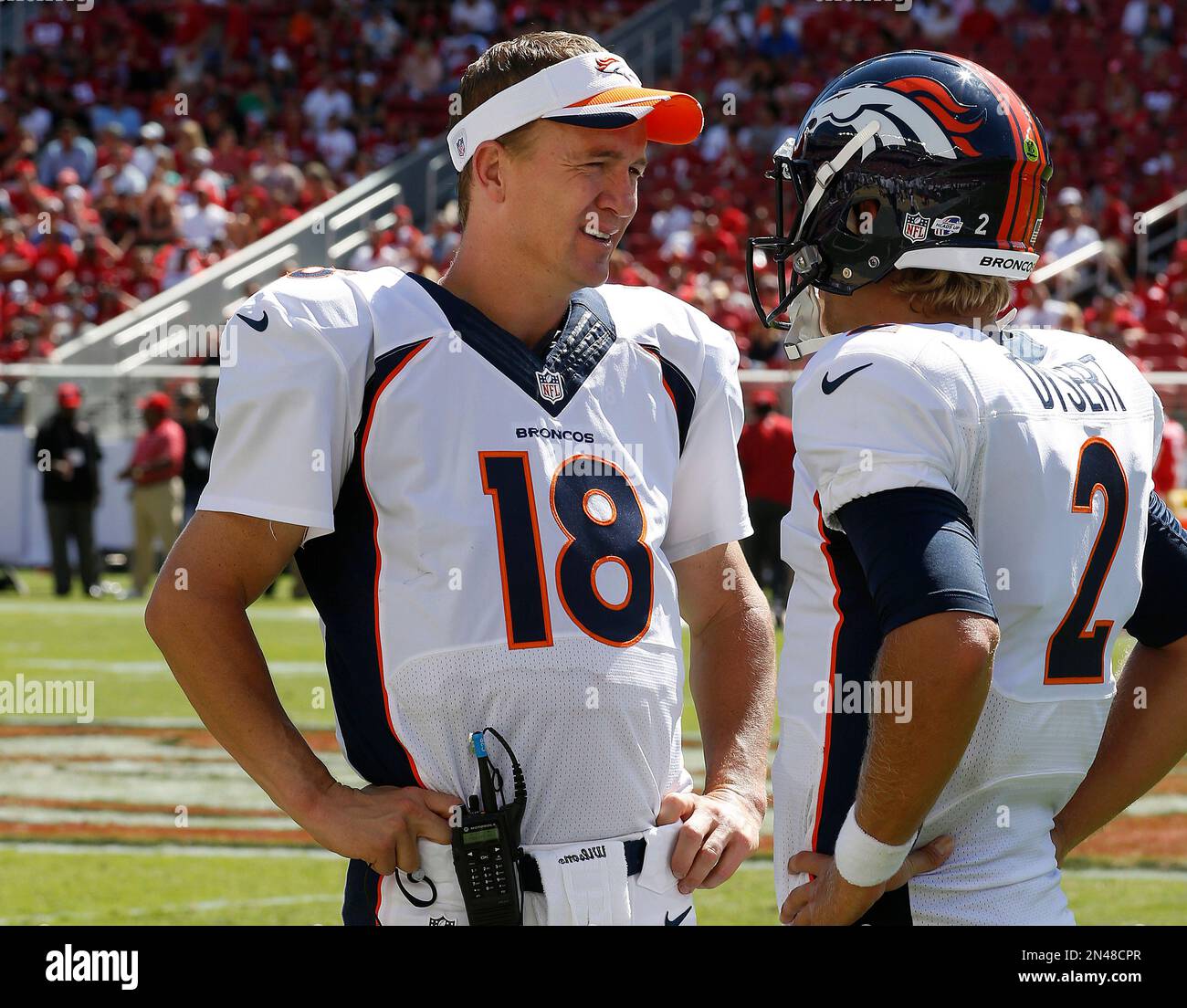 Denver Broncos quarterback Peyton Manning (18) talks with quarterback ...
