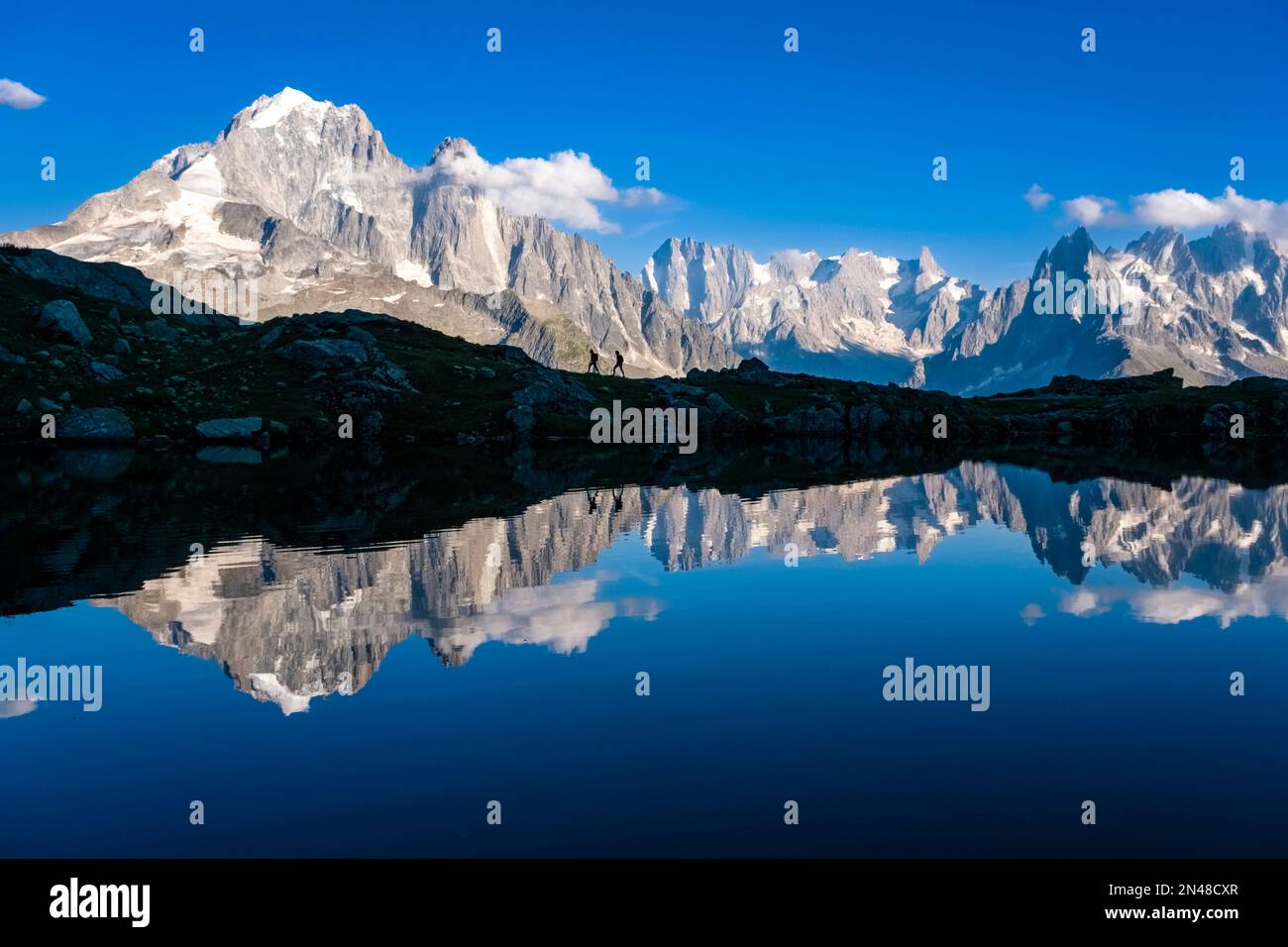 The peaks of the Mont Blanc massif are reflecting on the surface of Lacs des Chéserys, two ...