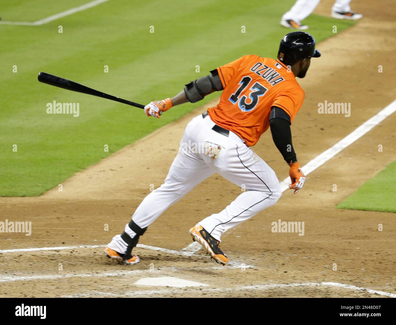 Miami Marlins' Marcell Ozuna (13) follows through on a RBI double in ...