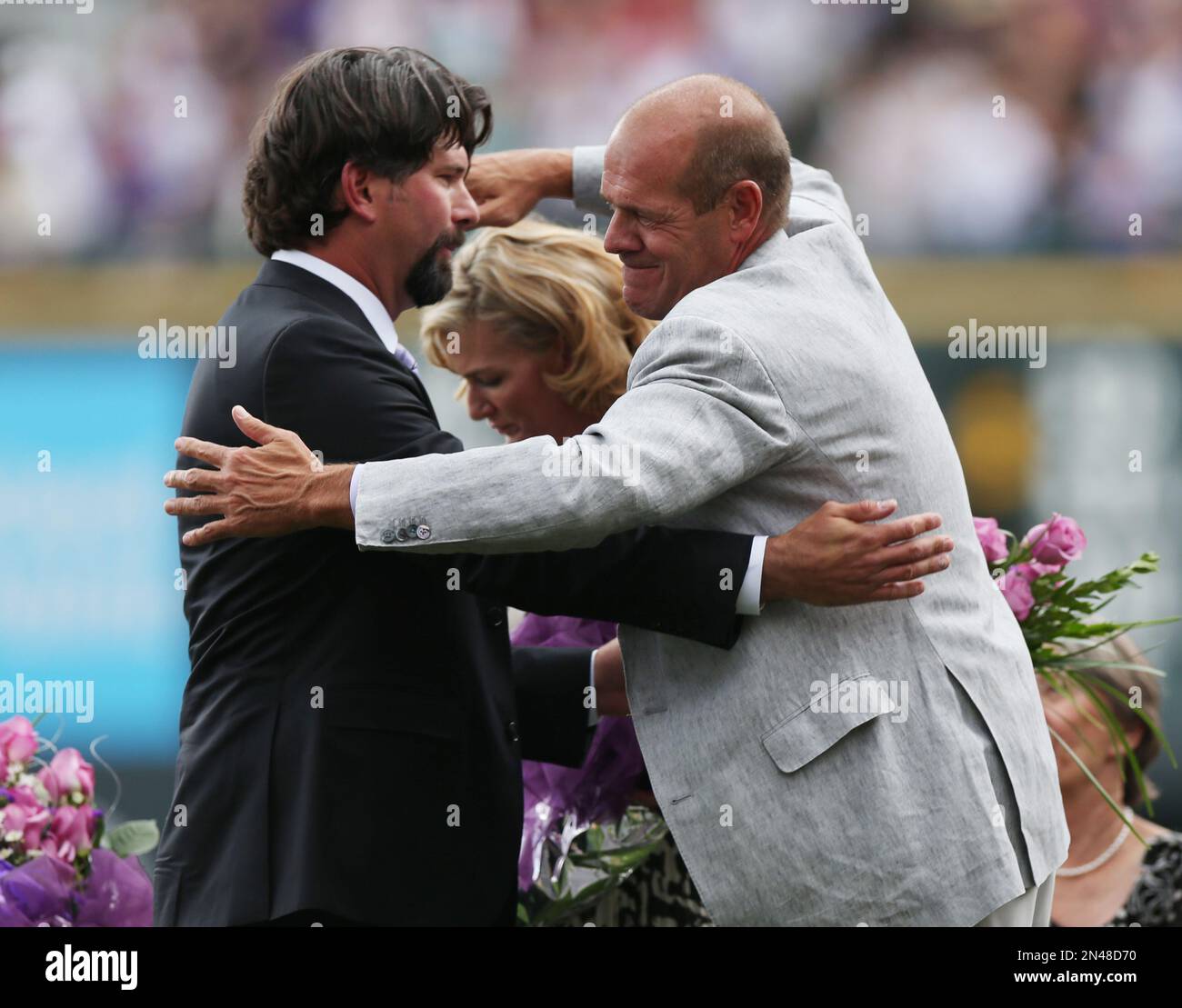 Retired Colorado Rockies first baseman Todd Helton, left, is hugged by ...