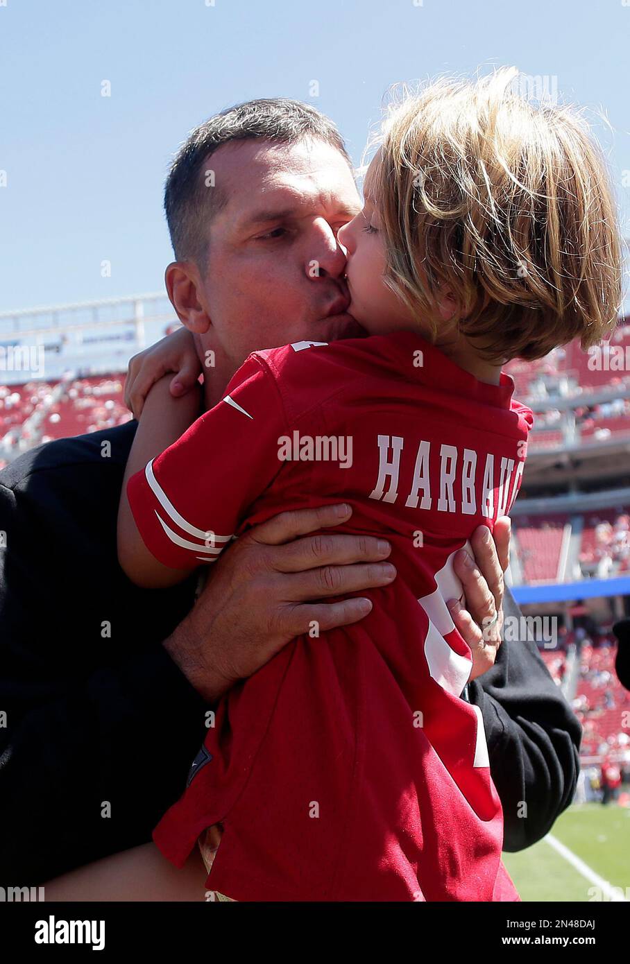San Francisco 49ers head coach Jim Harbaugh kisses his daughter Addie ...