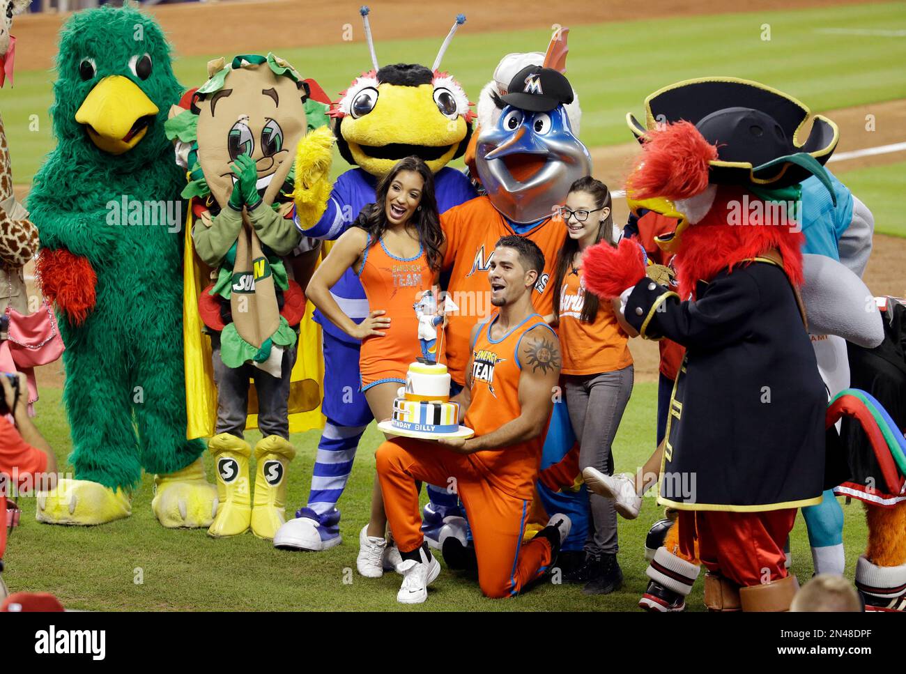 Mascots sing "Happy Birthday" to Miami Marlins mascot Billy the Marlin, center, during a ...