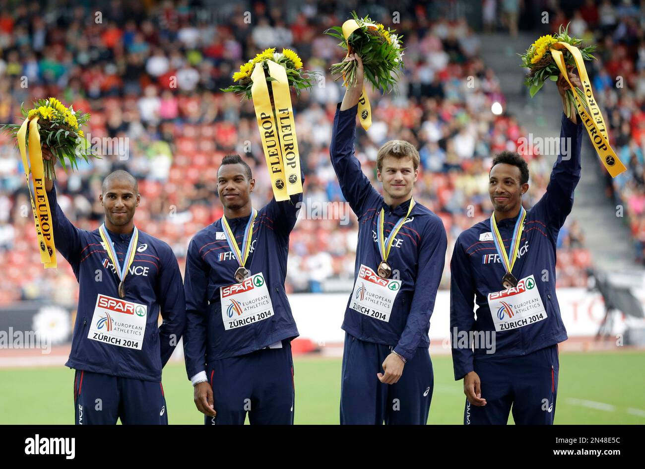 The bronze medal winning French relay team wave during the ceremony ...