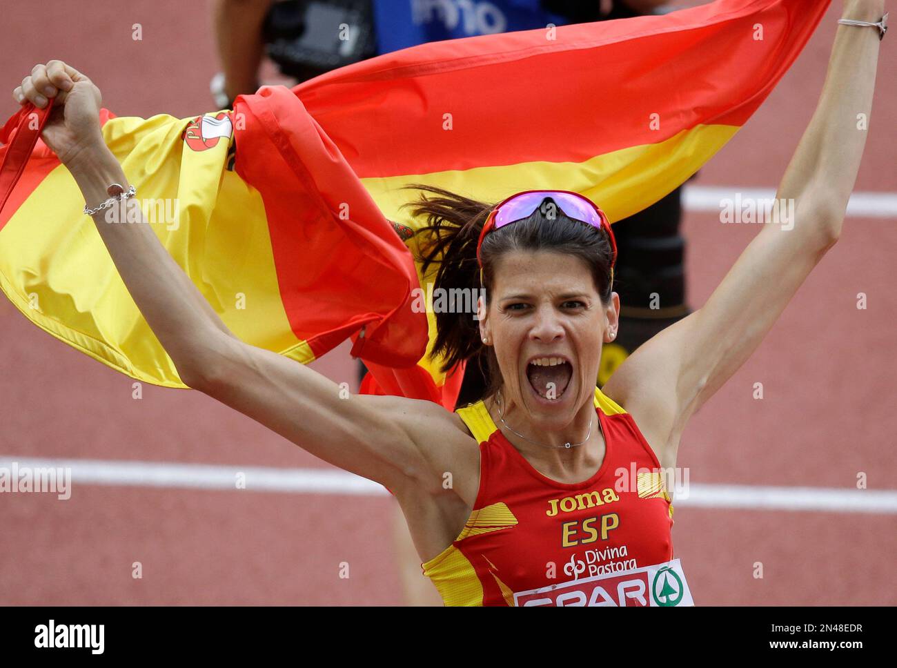 Spain's Ruth Beitia celebrates with the Spanish flag after winning the ...