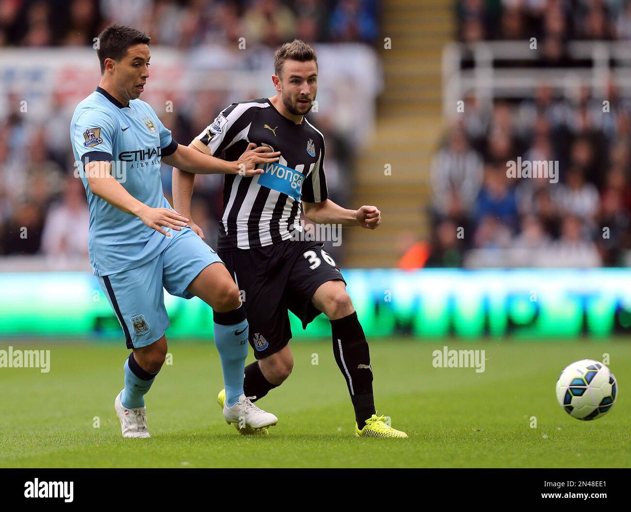 Manchester City's Samir Nasri, left, vies for the ball with Newcastle ...