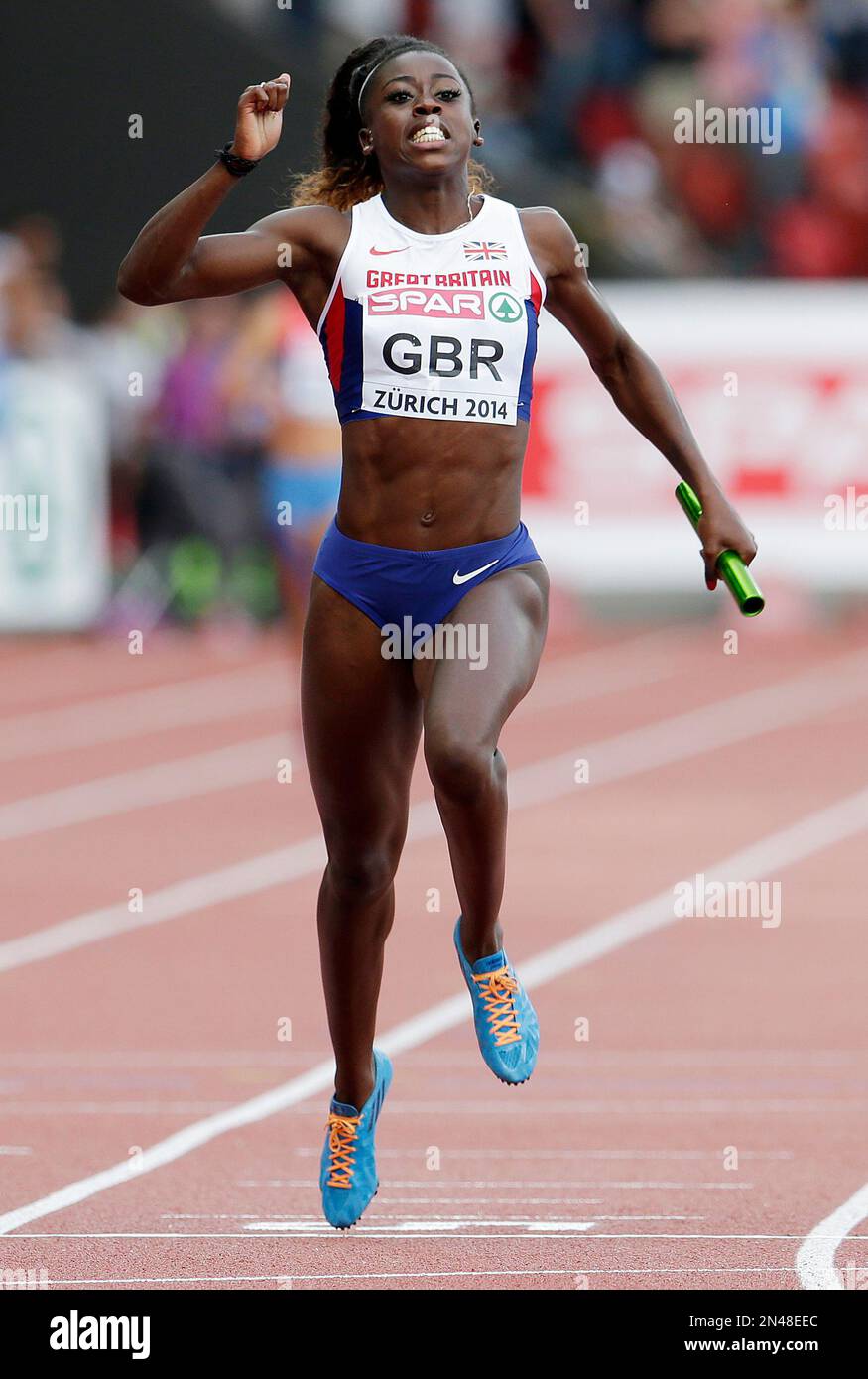 Britain's Desiree Henry crosses the finish line to help her team win ...