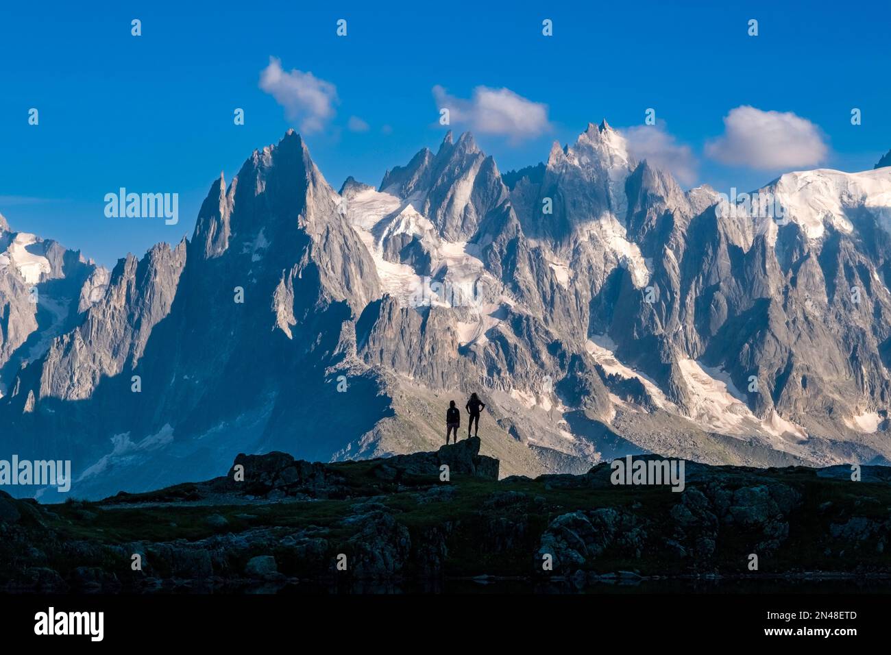 The peaks of the Mont Blanc massif are reflecting on the surface of Lacs des Chéserys, two ...