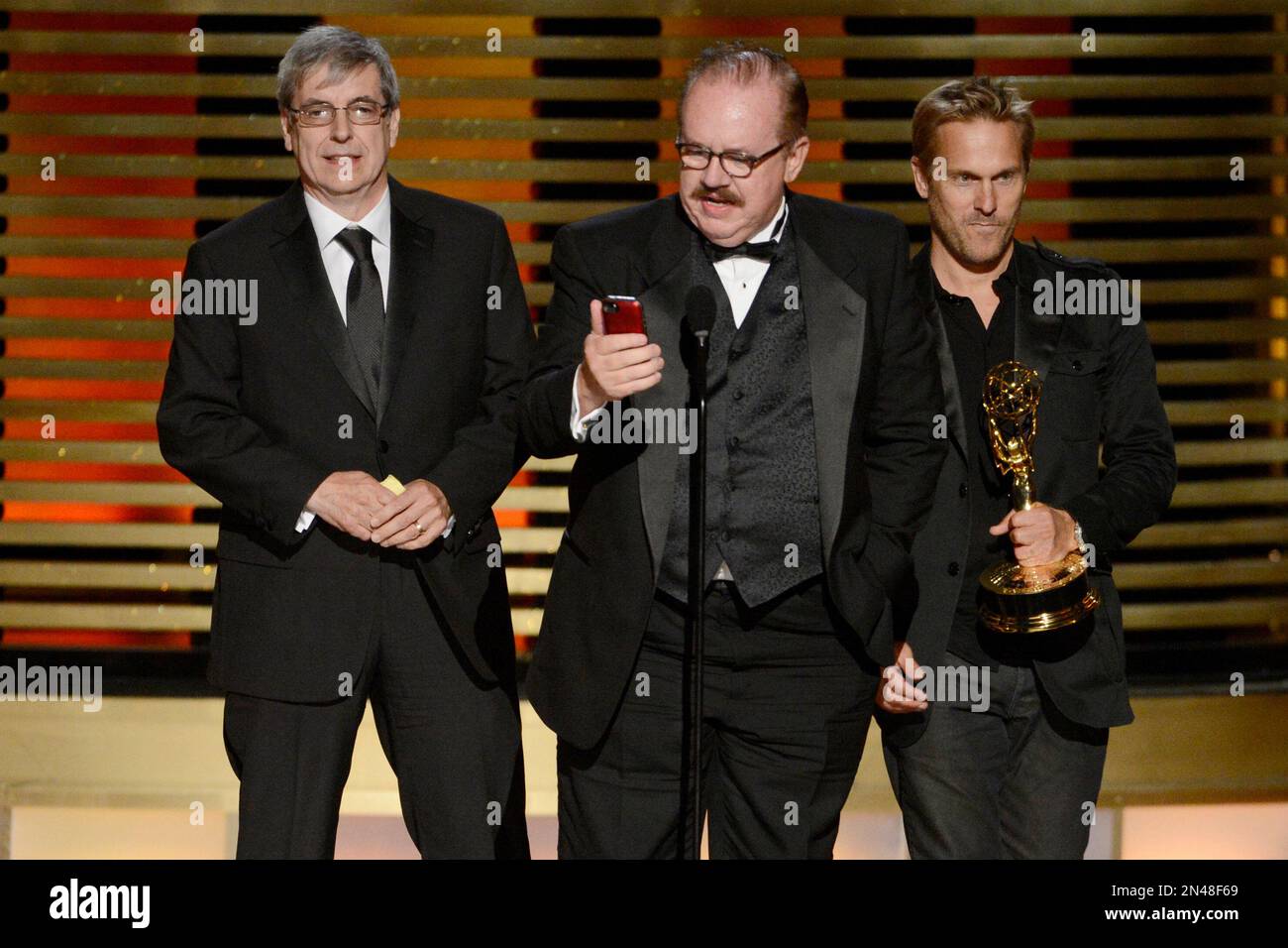 Robert Muller, and from left, Emmett Loughran and Andrew Jansen accept ...