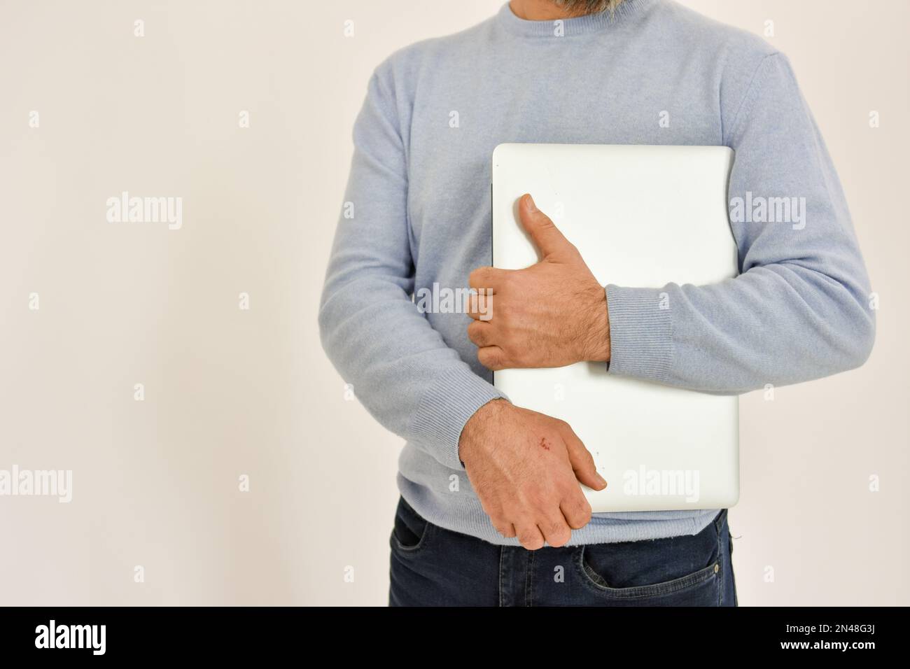 Adult man holding laptop computer isolated on white background Stock ...