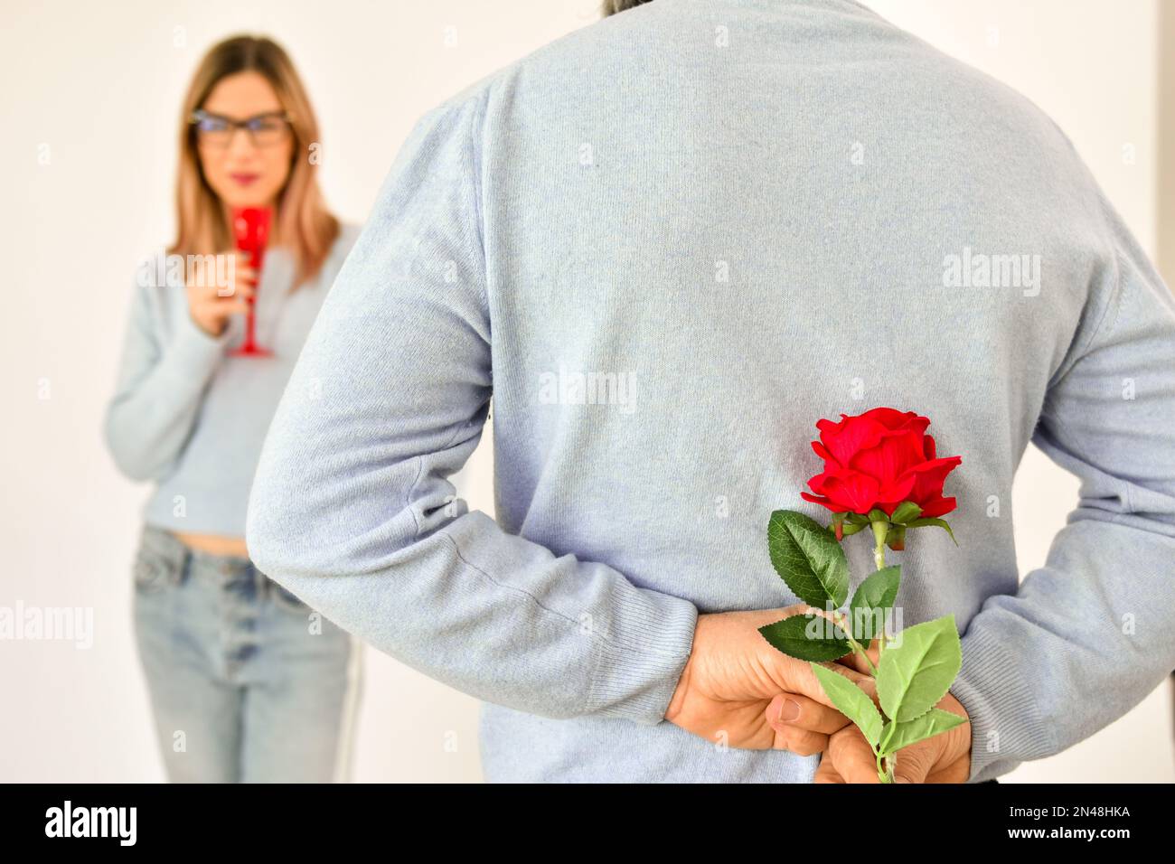 Husband hiding flower behind back hi-res stock photography and images ...