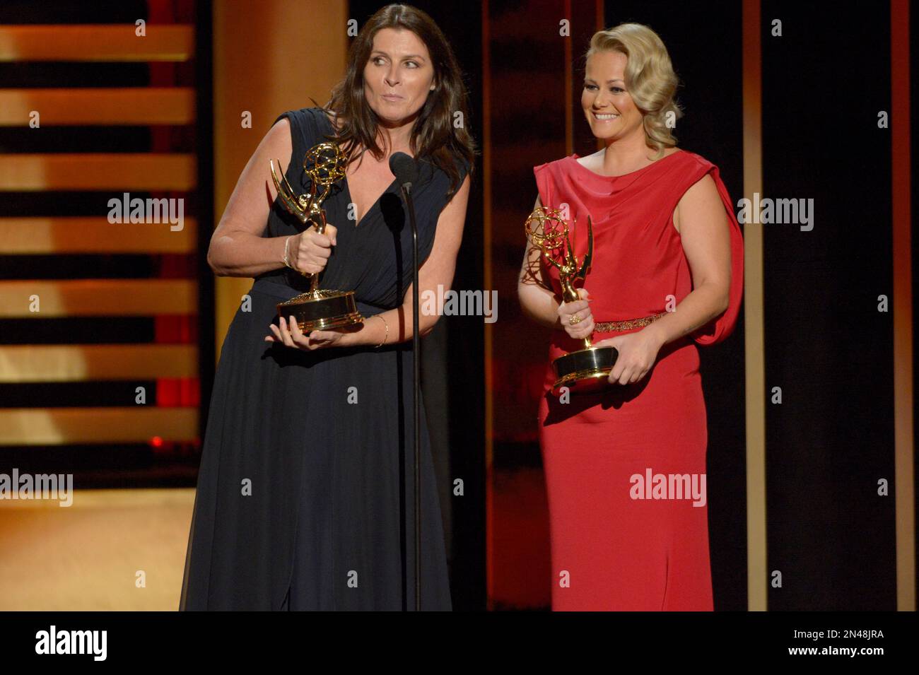 Grainne O'Sullivan, left, and Marina Toybina accept the award for ...
