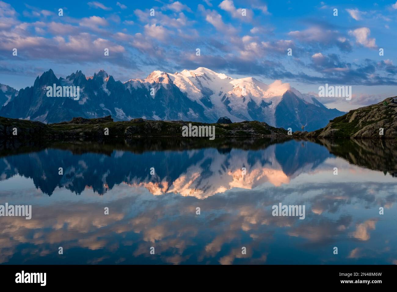 The peaks of the Mont Blanc massif and some clouds, reflecting on the ...