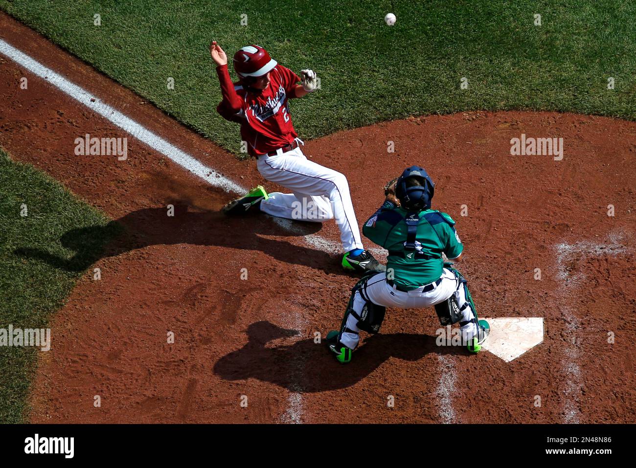 Lynnwood's Karsen Tjarnberg (24) scores on a double by Tyler Durbin as ...