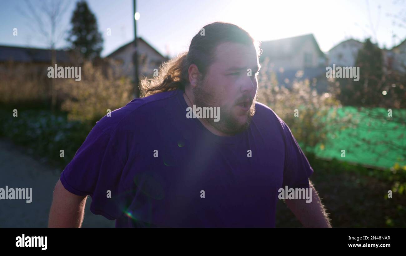 One overweight man starts to run outside getting back to into shape ...