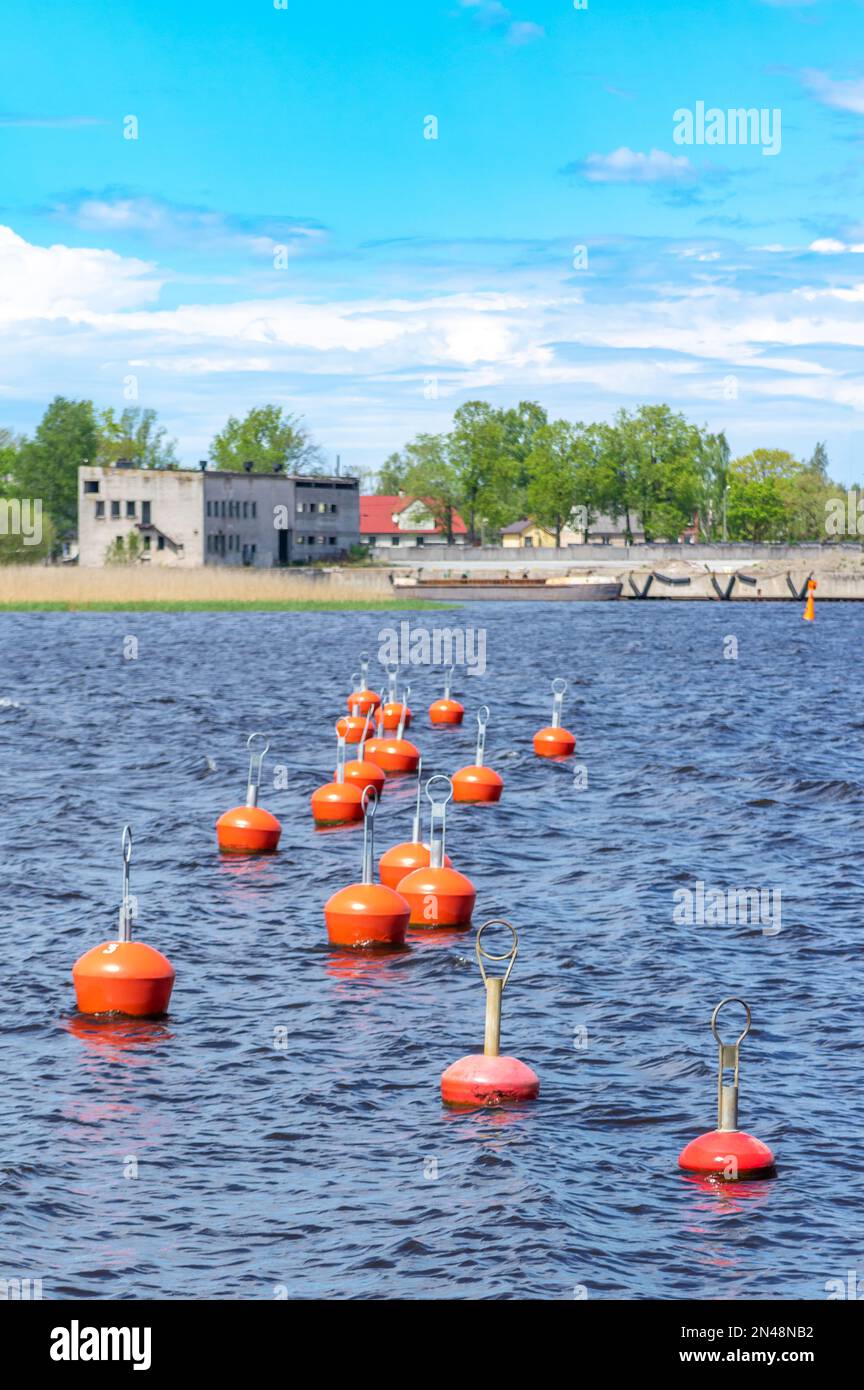 Many red buoys floating in water Stock Photo - Alamy
