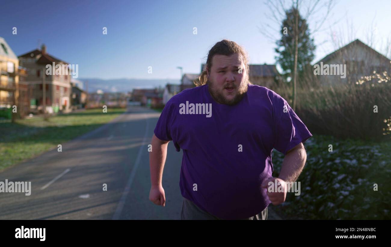 One overweight man starts to run outside getting back to into shape ...
