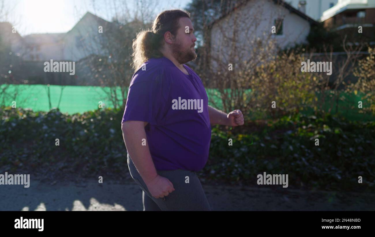 One overweight man starts to run outside getting back to into shape ...