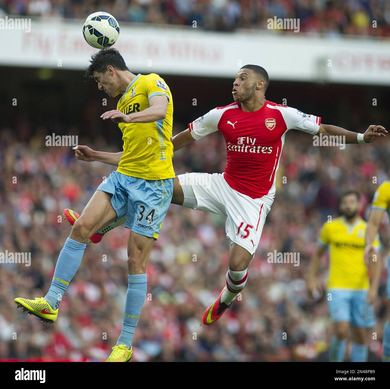 Arsenal's Alex Oxlade-Chamberlain, in the air with Crystal Palace's ...