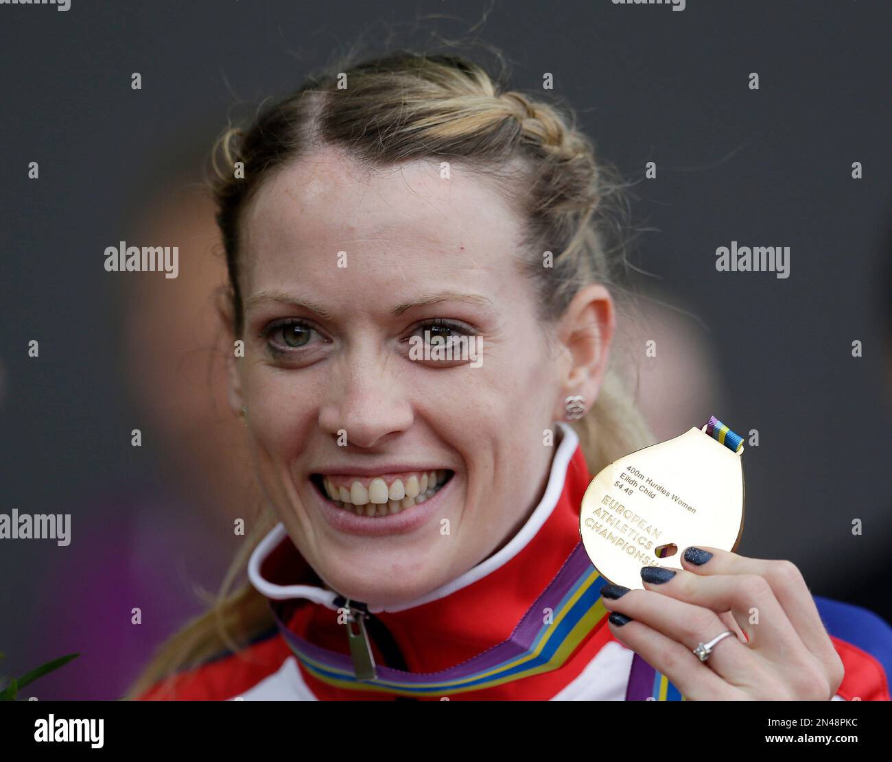 Britain's Eilidh Child shows the gold medal she won in the 400m hurdles ...