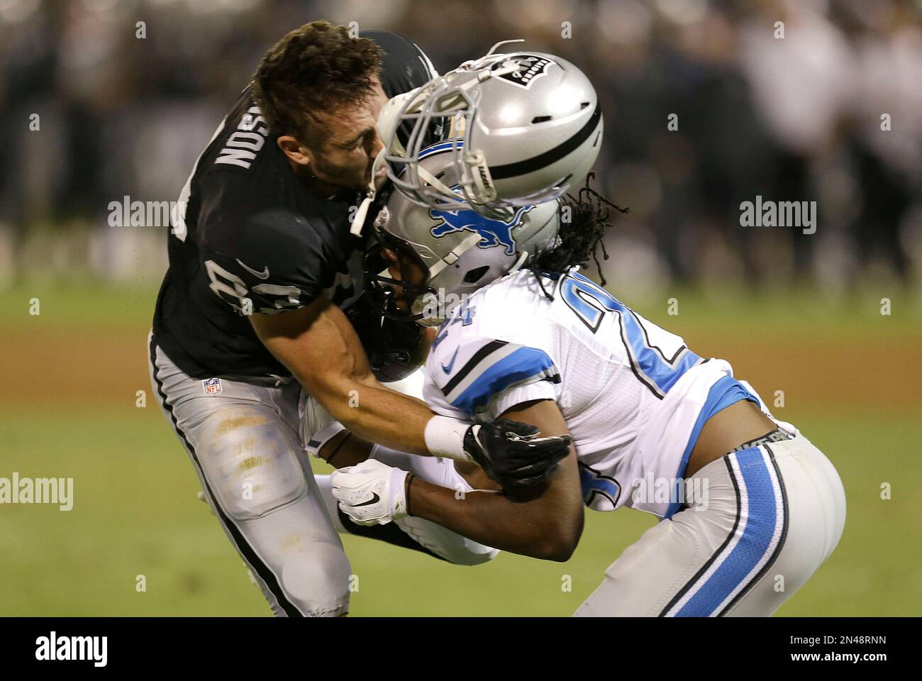 Oakland Raiders tight end Scott Simonson, left, loses his helmet and ...