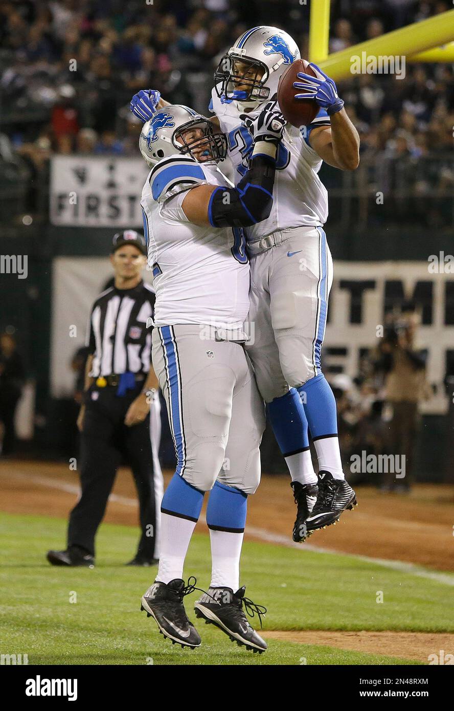 Detroit Lions running back George Winn, right, celebrates after running ...