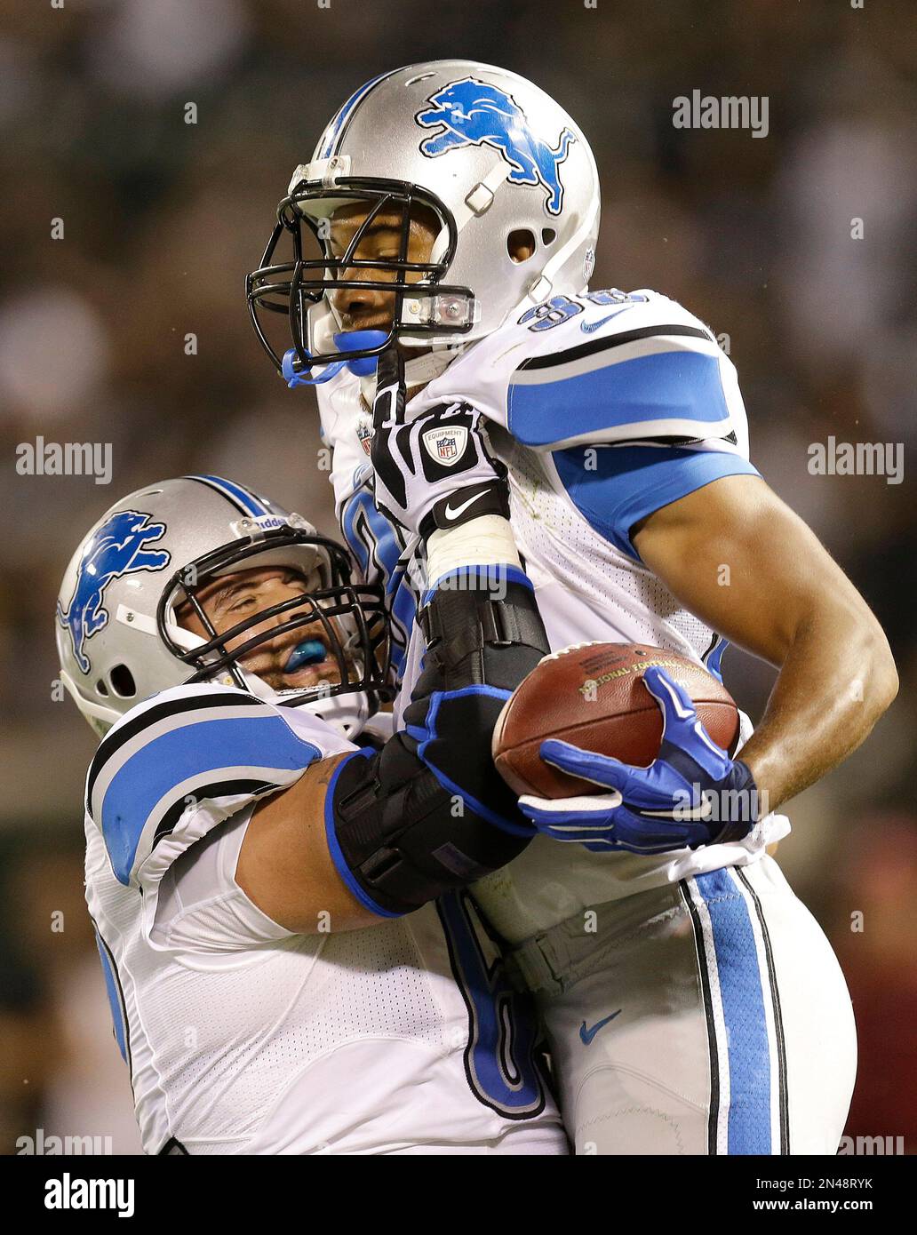 Detroit Lions running back George Winn, right, celebrates with guard ...