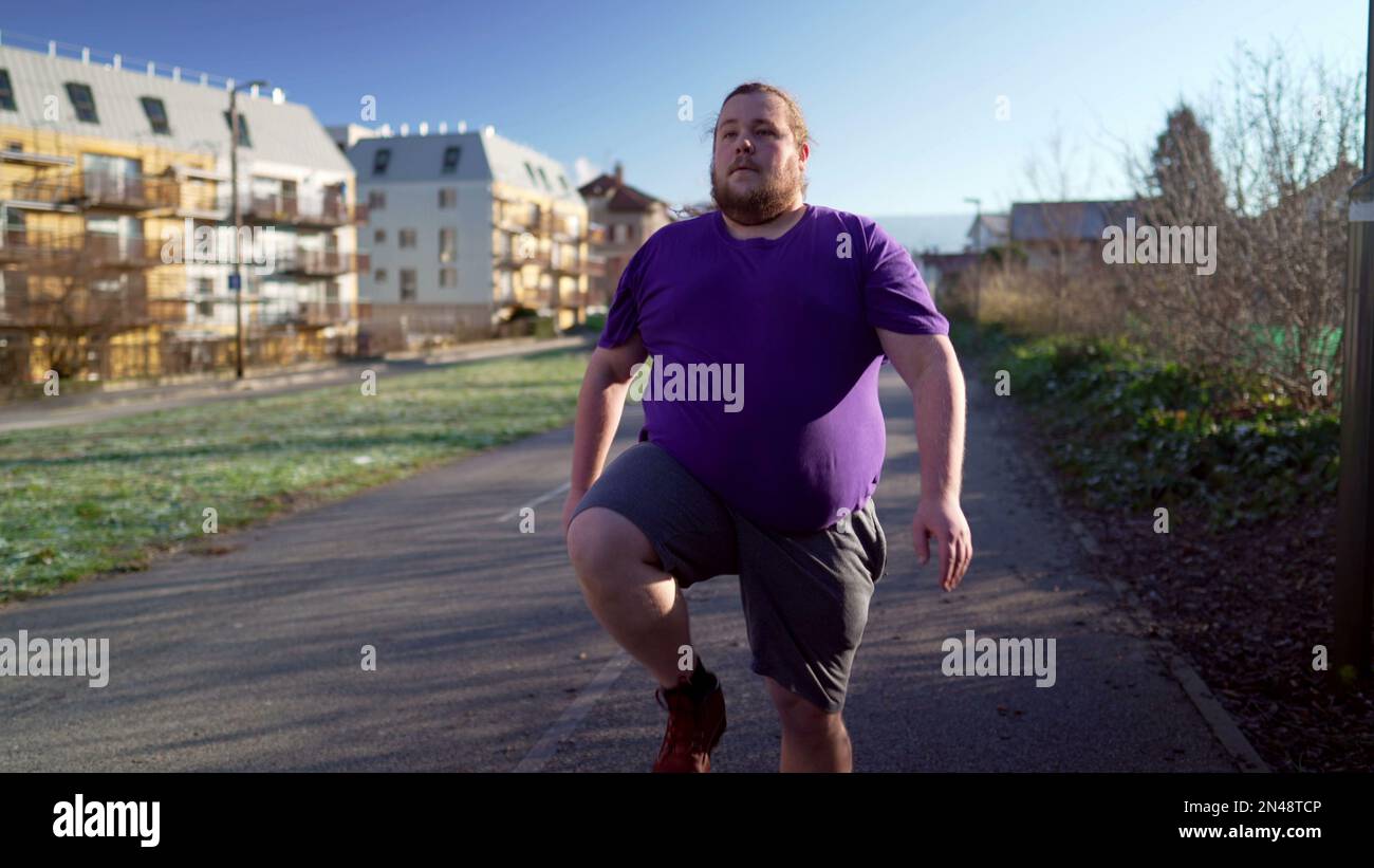 One overweight young man moving body before exercise. Plus size male ...