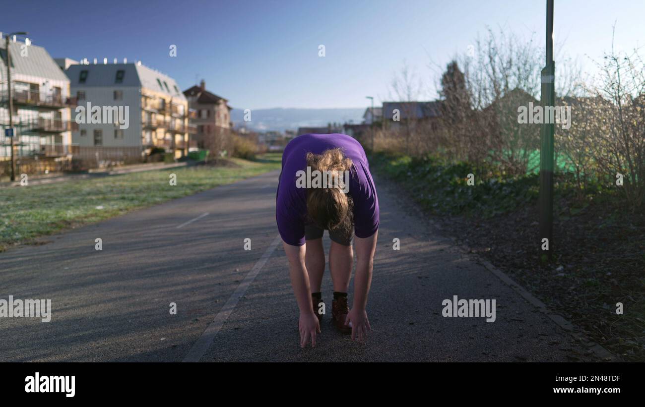 One young overweight man stretching legs before run. Back to fitness ...