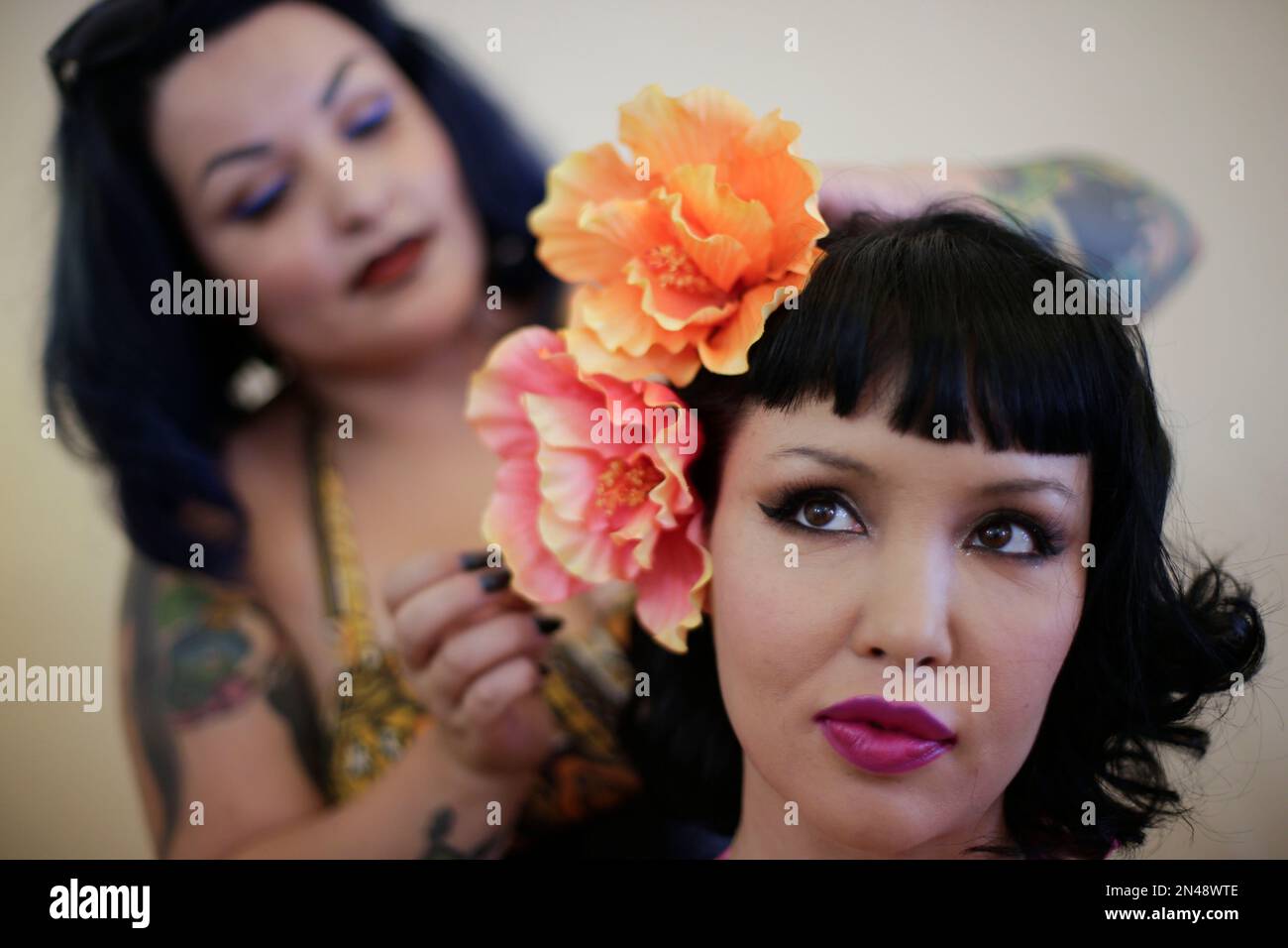 Masuimi Max, right, laughs as she gets a hairstyle by Jennifer Corona ...