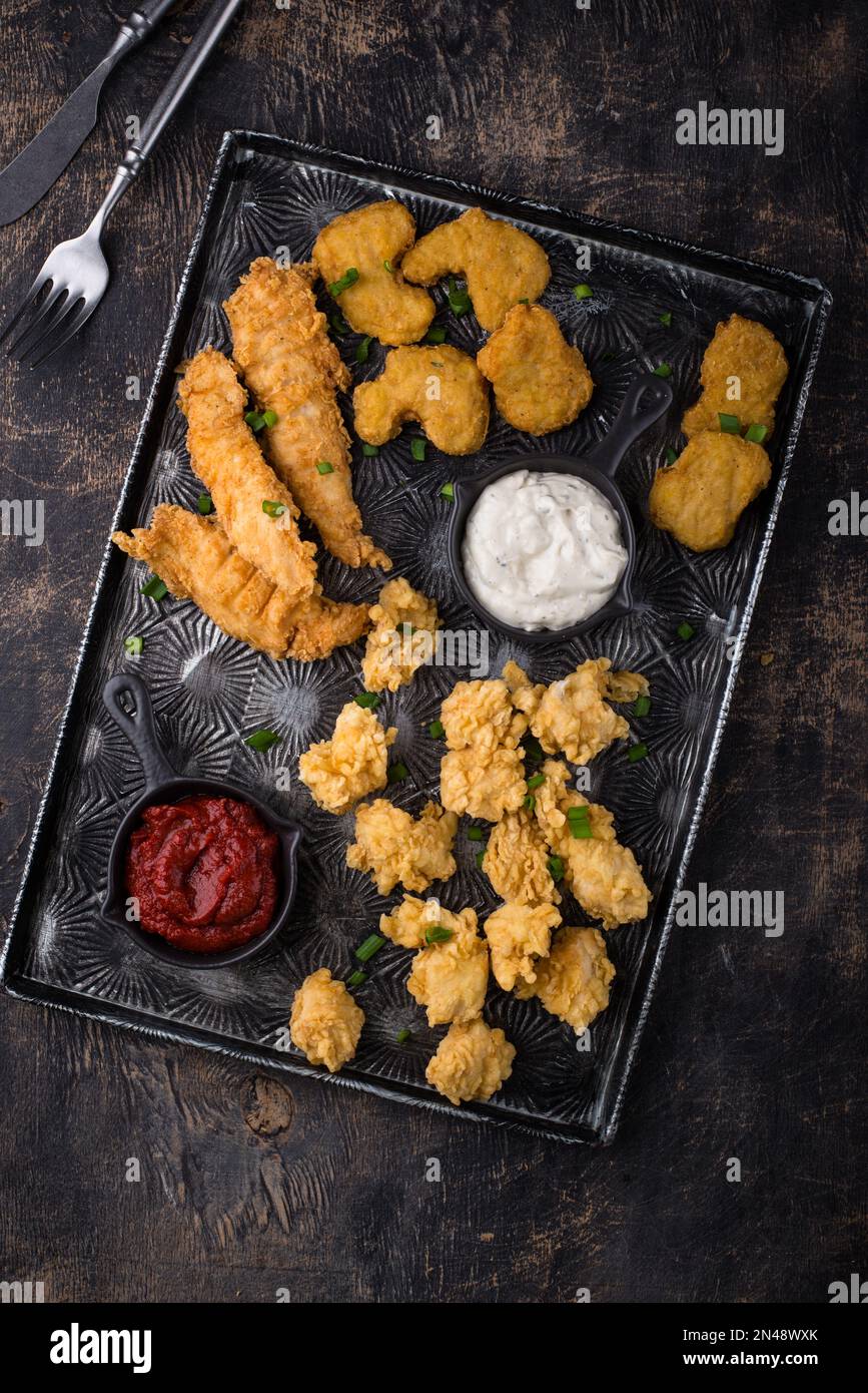 Chicken nuggets, strips and bites Stock Photo - Alamy