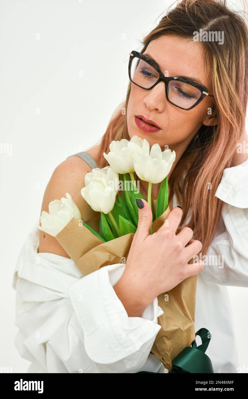 Bouquet of white tulips in a female hand on a white background Stock ...