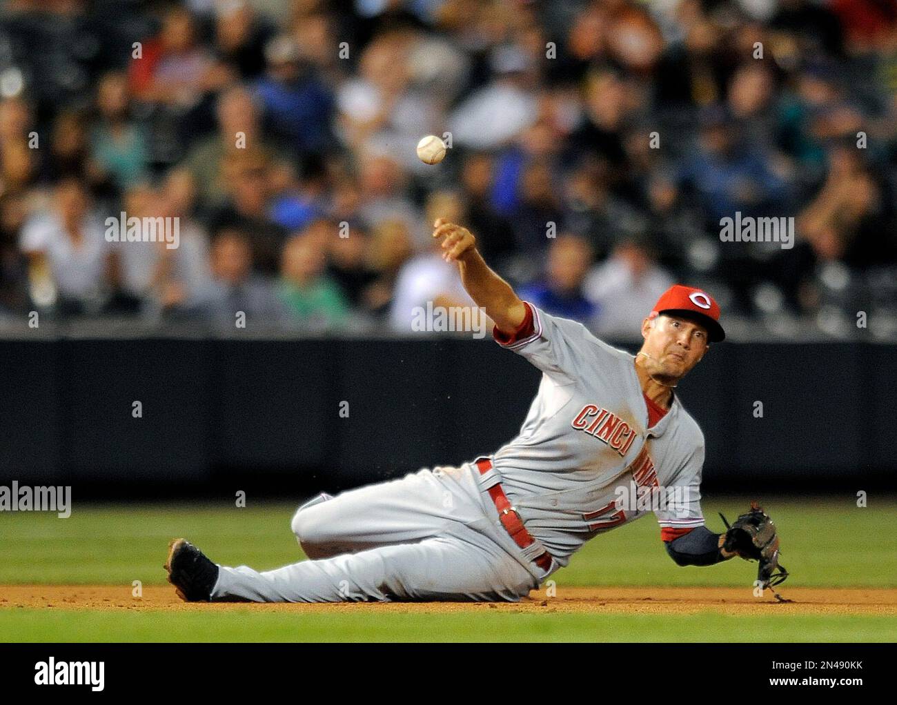 Cincinnati Reds third baseman Kris Negron throws to first base from the ...