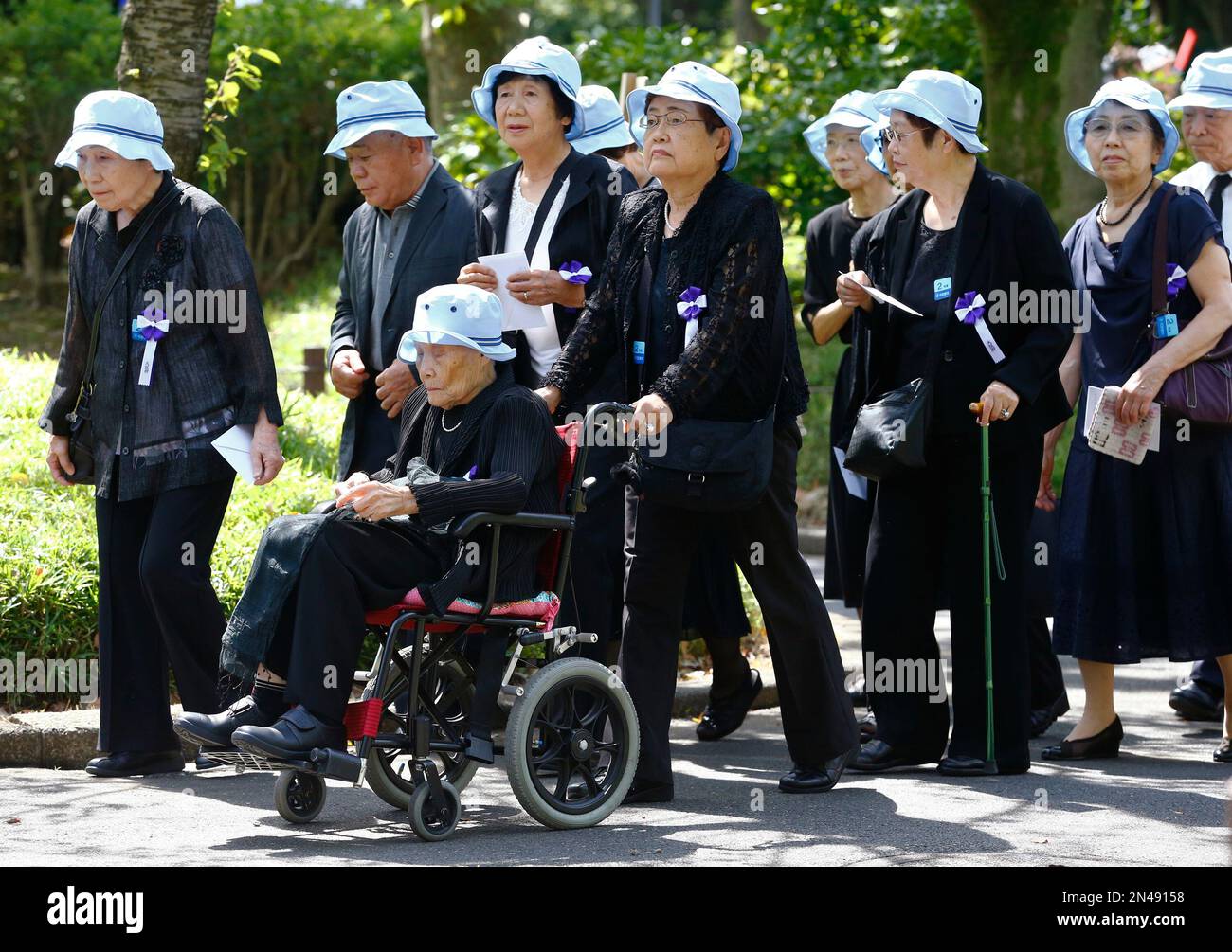 Family members of the WWII war dead, along with others, arrive for a ...