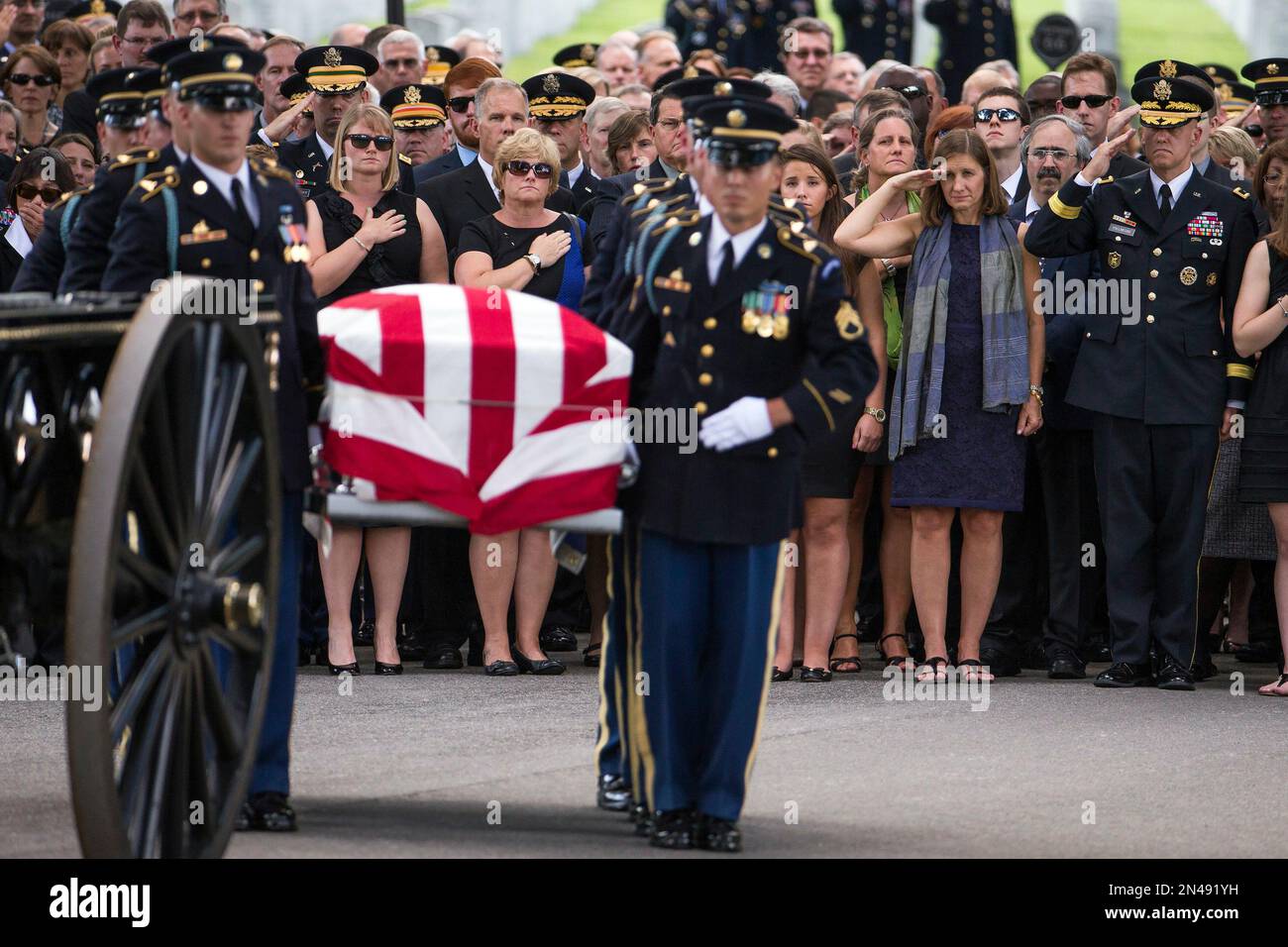 Retired Col. Susan Myers, second from right, salutes as the casket of ...