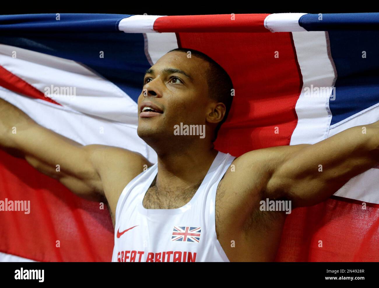 Britain's William Sharman poses with the national flag after finishing ...