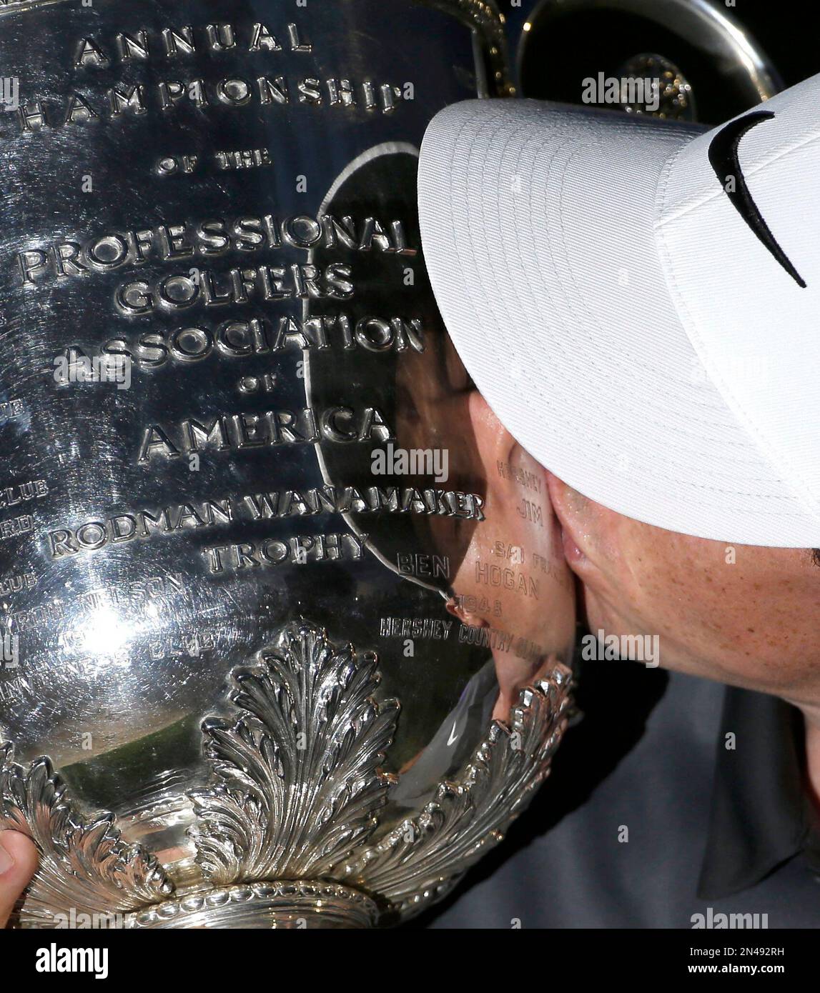 Rory McIlroy, of Northern Ireland, holds up the Wanamaker Trophy after ...