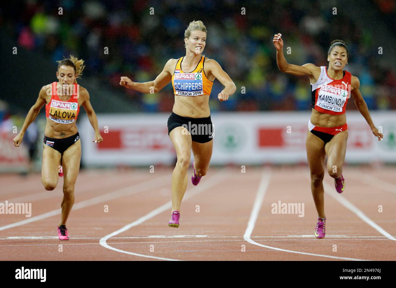 Netherlands' Dafne Schippers, center, crosses the finsih line to win ...