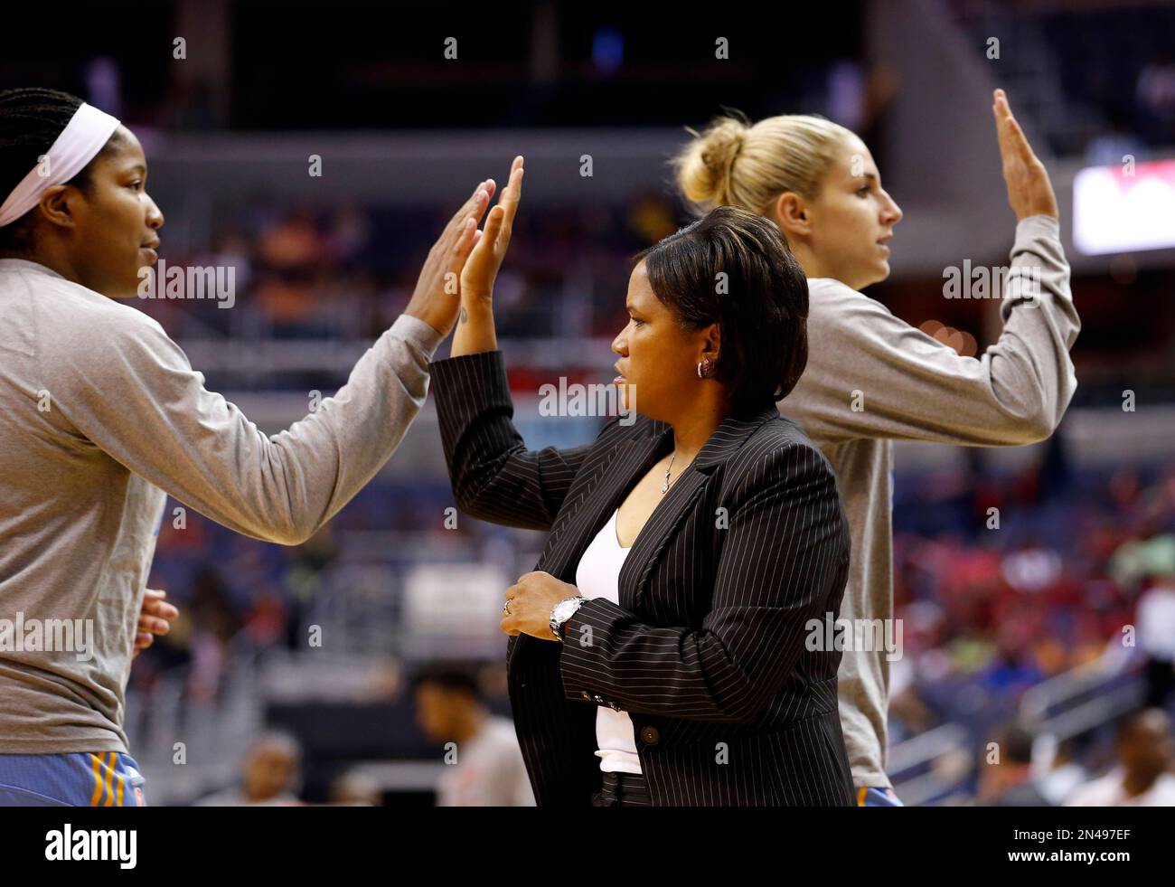 Chicago Sky head coach Pokey Chatman high fives her team before a WNBA ...