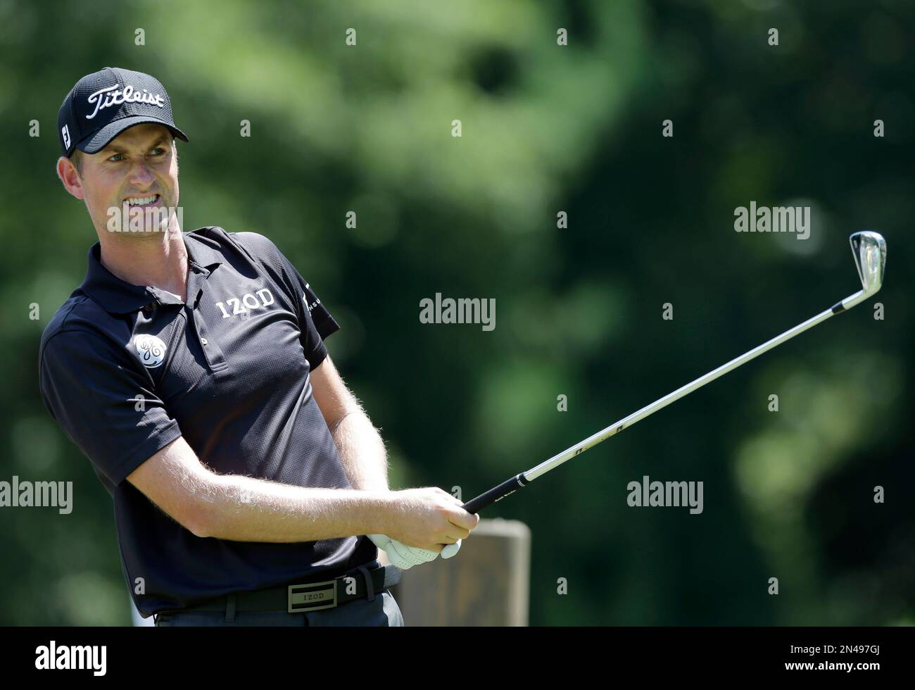 Webb Simpson watches his tee shot on the second hole during the pro-am ...