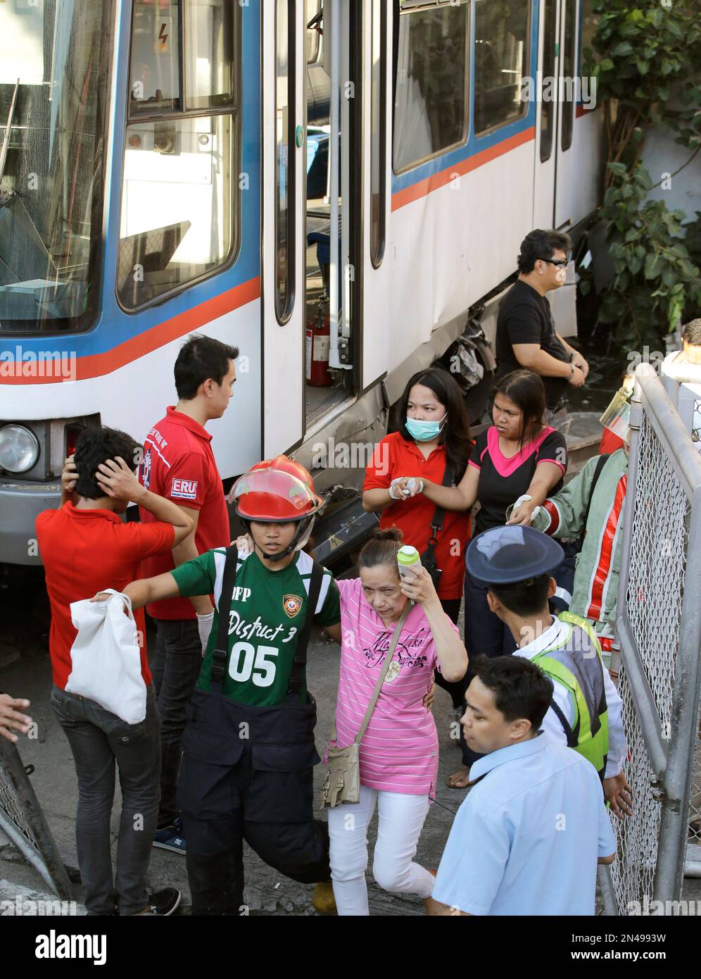 Rescuers rush injured passengers to a hospital after an elevated commuter train known as Metro ...