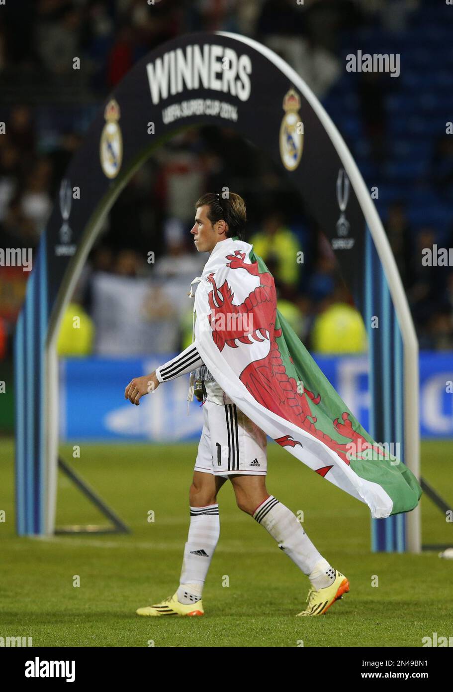 Real Madrid’s Gareth Bale walks with the trophy after winning the UEFA ...