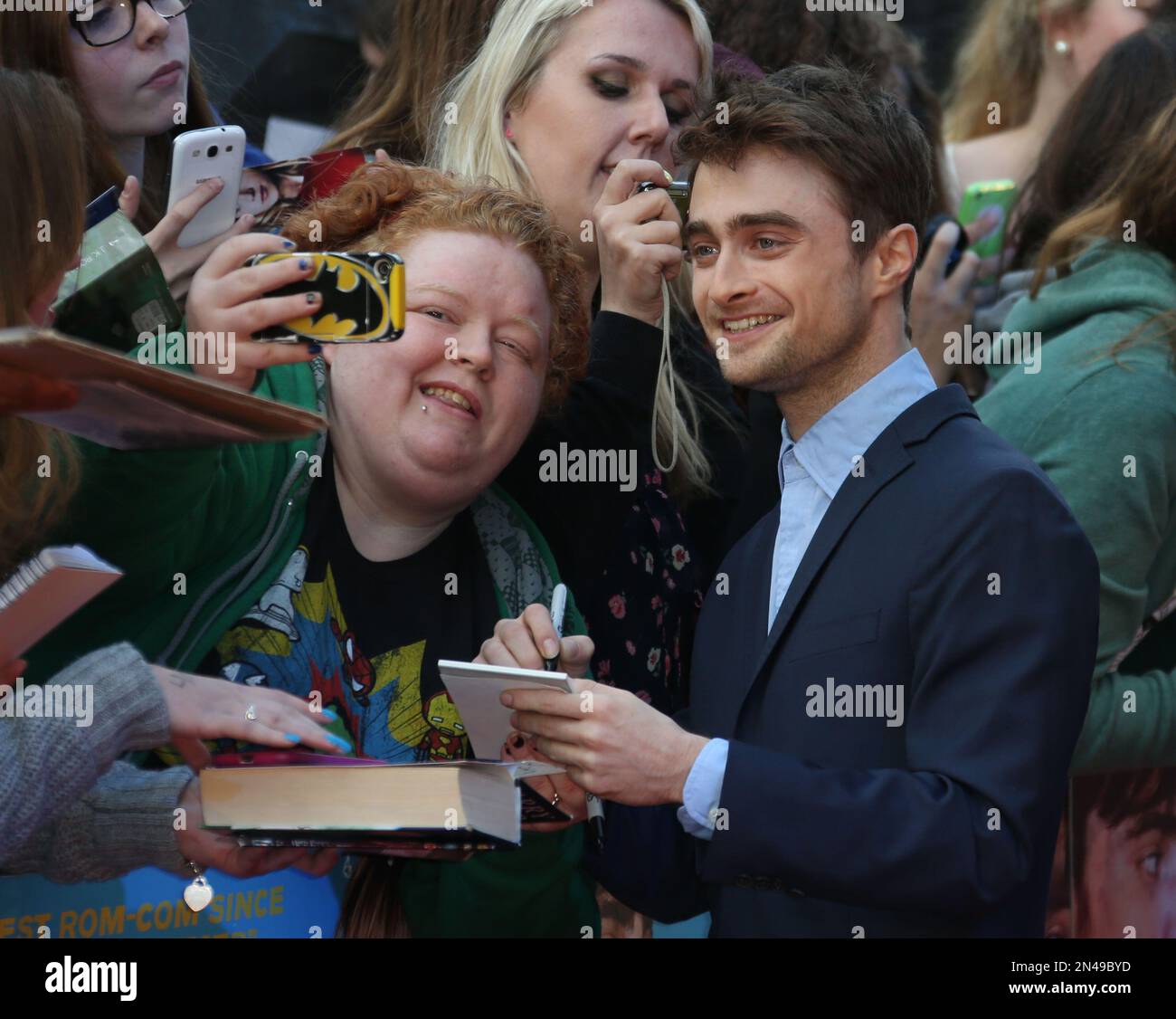 British actor Daniel Radcliffe poses for photographs with fans as he ...
