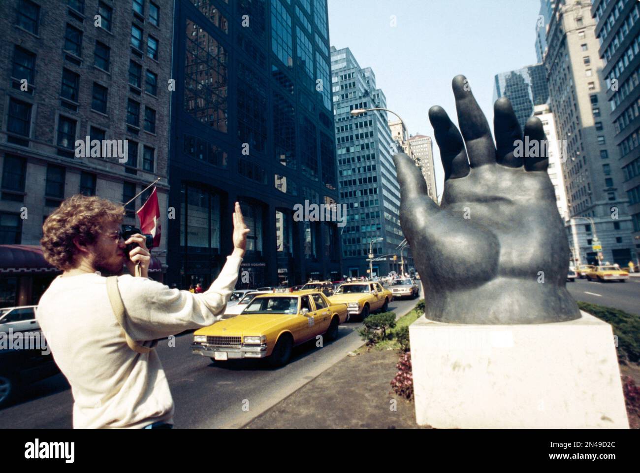 A pedestrian takes a picture of a Fernado Botero sculpture in New York ...