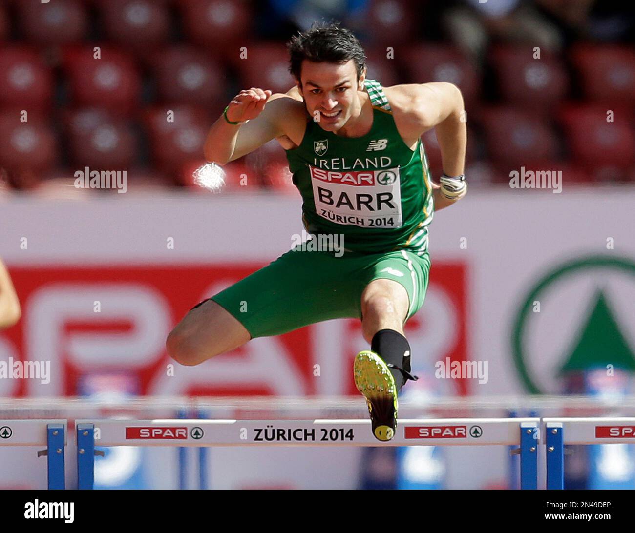 Ireland's Thomas Barr clears a hurdle in his 400m hurdles heat during ...