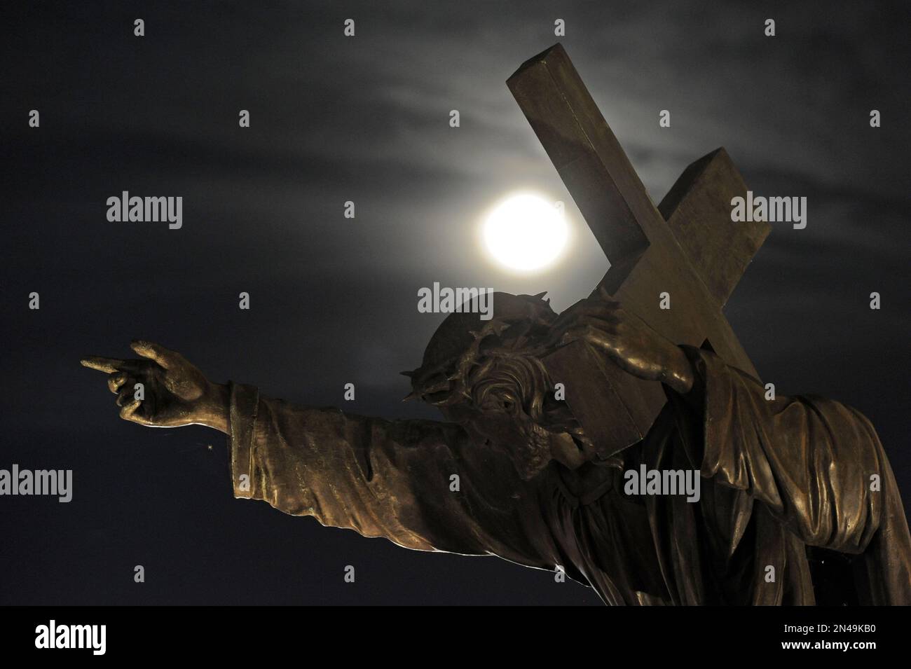 A supermoon rises above a Jesus Christ statue in front of the Holy ...