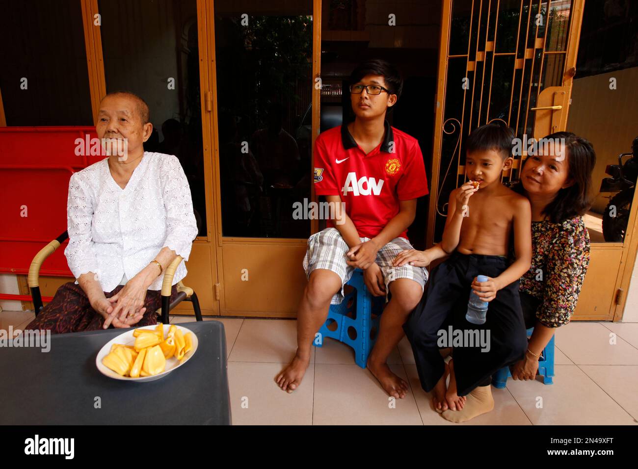 In this photo taken, July 3, 2014, a dairy writer Poch Younly's family ...