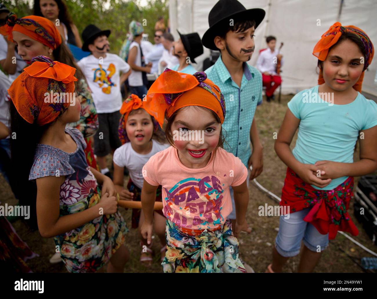 Larisa, 8 years-old, center, a Romanian Roma girl smiles while waiting ...