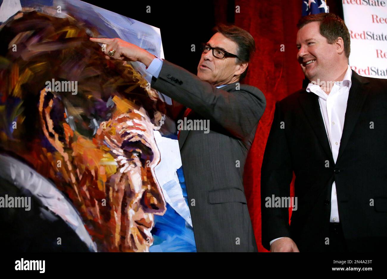 Emcee Erick Erickson, right, smiles as Texas Gov. Rick Perry points to ...