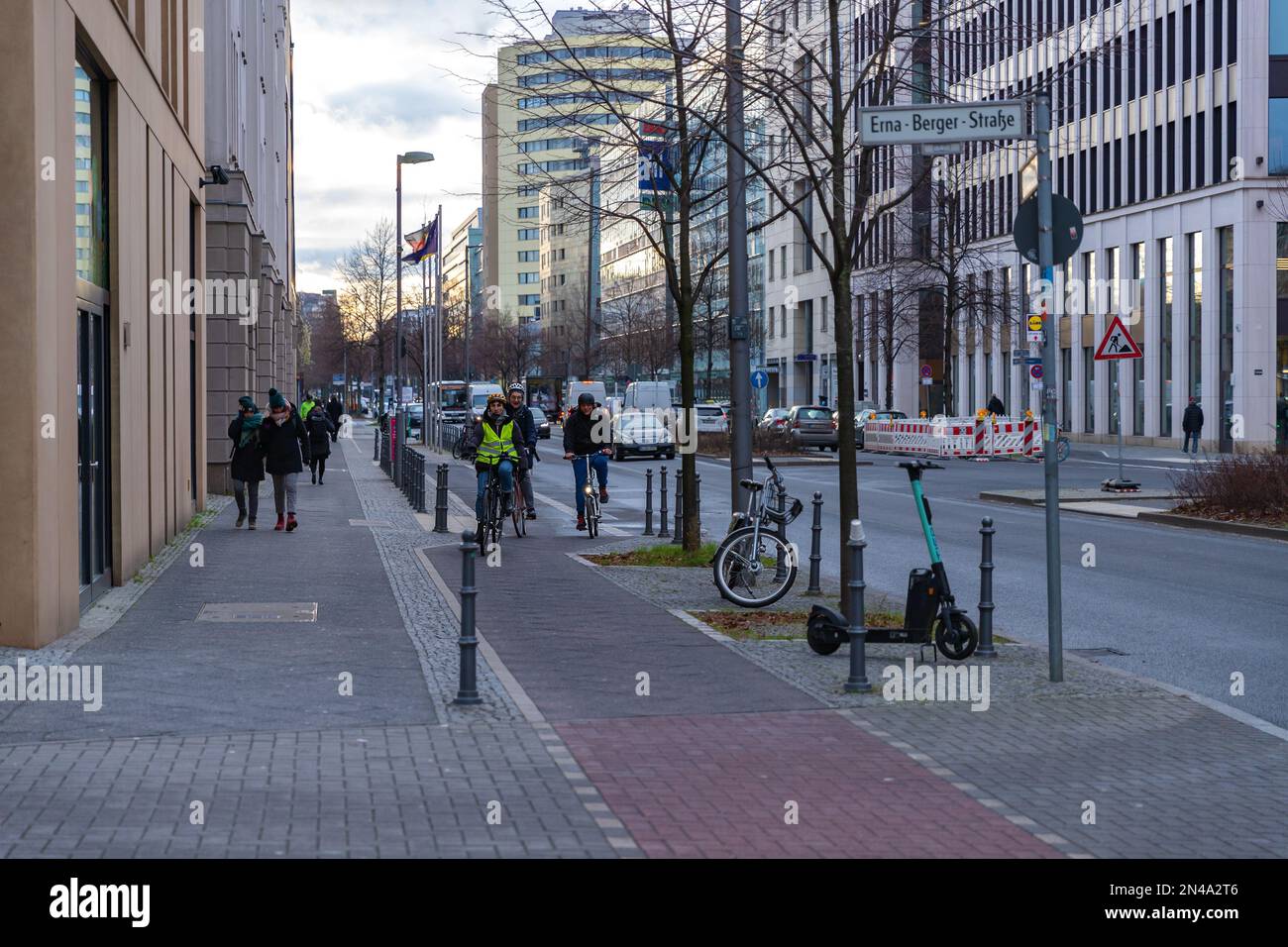 A bike path or a cycle path in Berlin, Germany. People and cyclists on ...